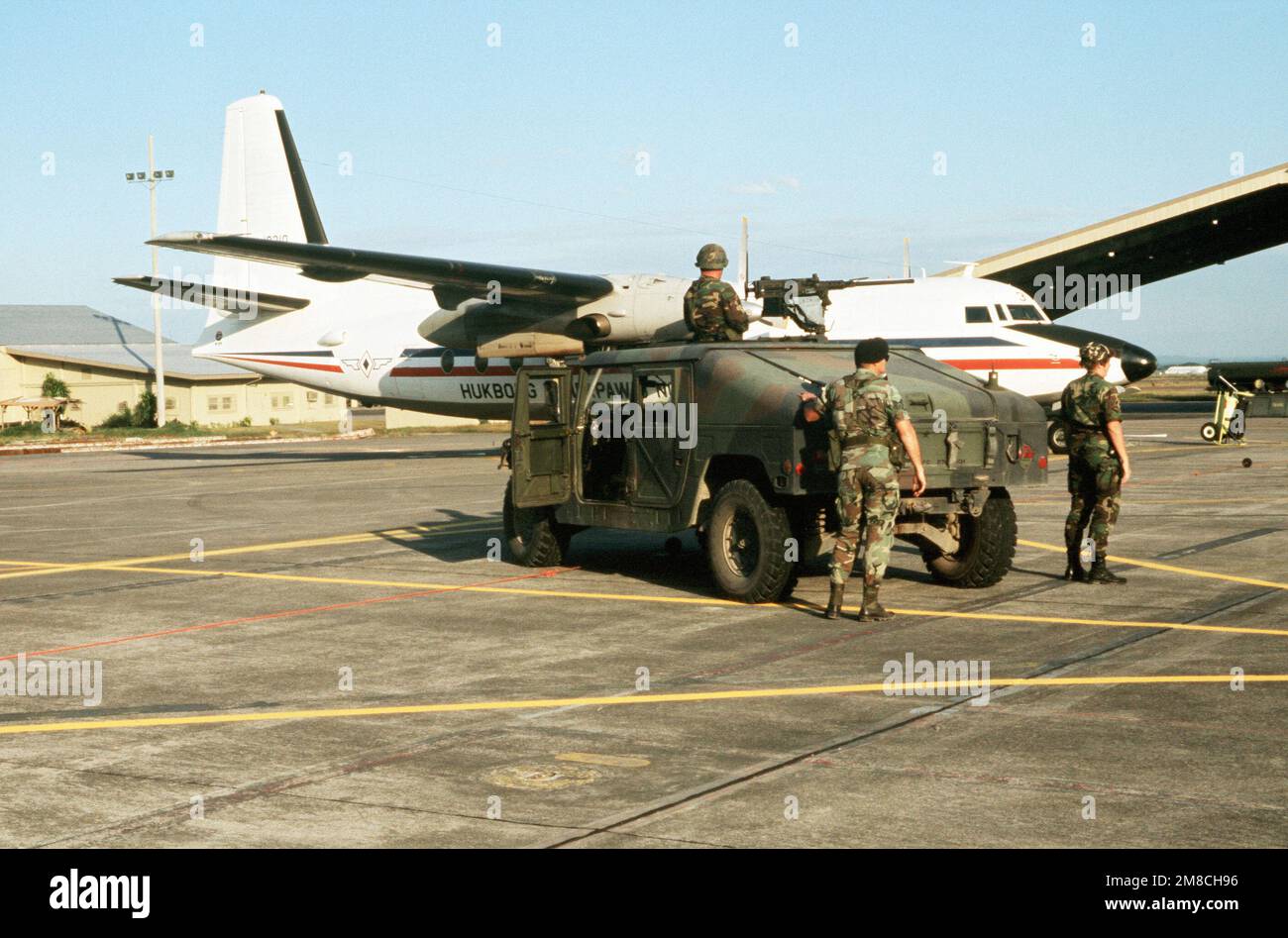 An airman mans the M-2 .50-caliber machine gun mounted atop an M998 ...
