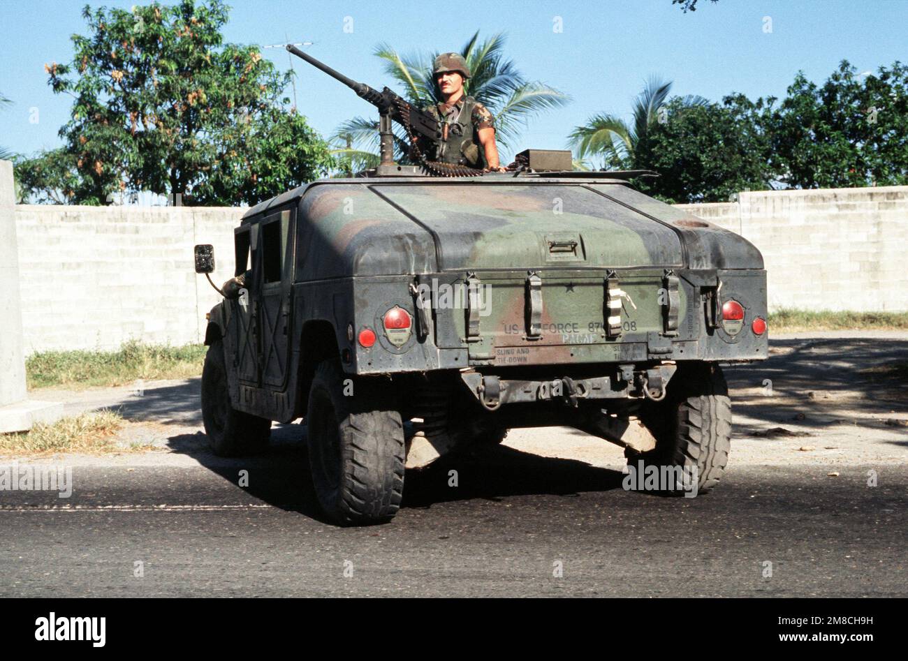 A member of a U.S. Air Force security team mans the M-2 .50-caliber ...