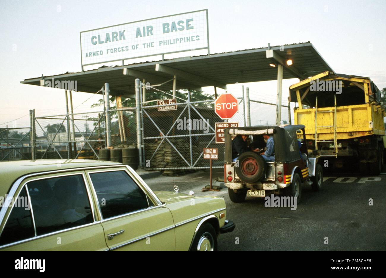 Vehicles are checked over before being allowed to enter the front gate ...