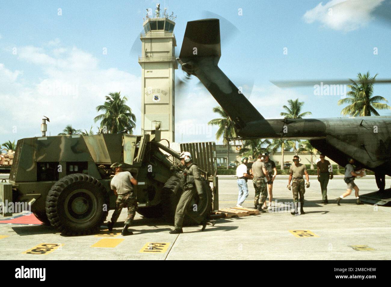 A flight crewman from a Marine Corps CH-53D Sea Stallion helicopter ...