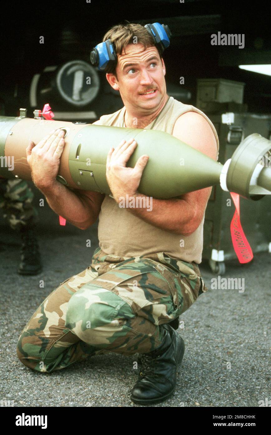 An airman assigned to the 3rd Tactical Fighter Wing holds up a laser ...