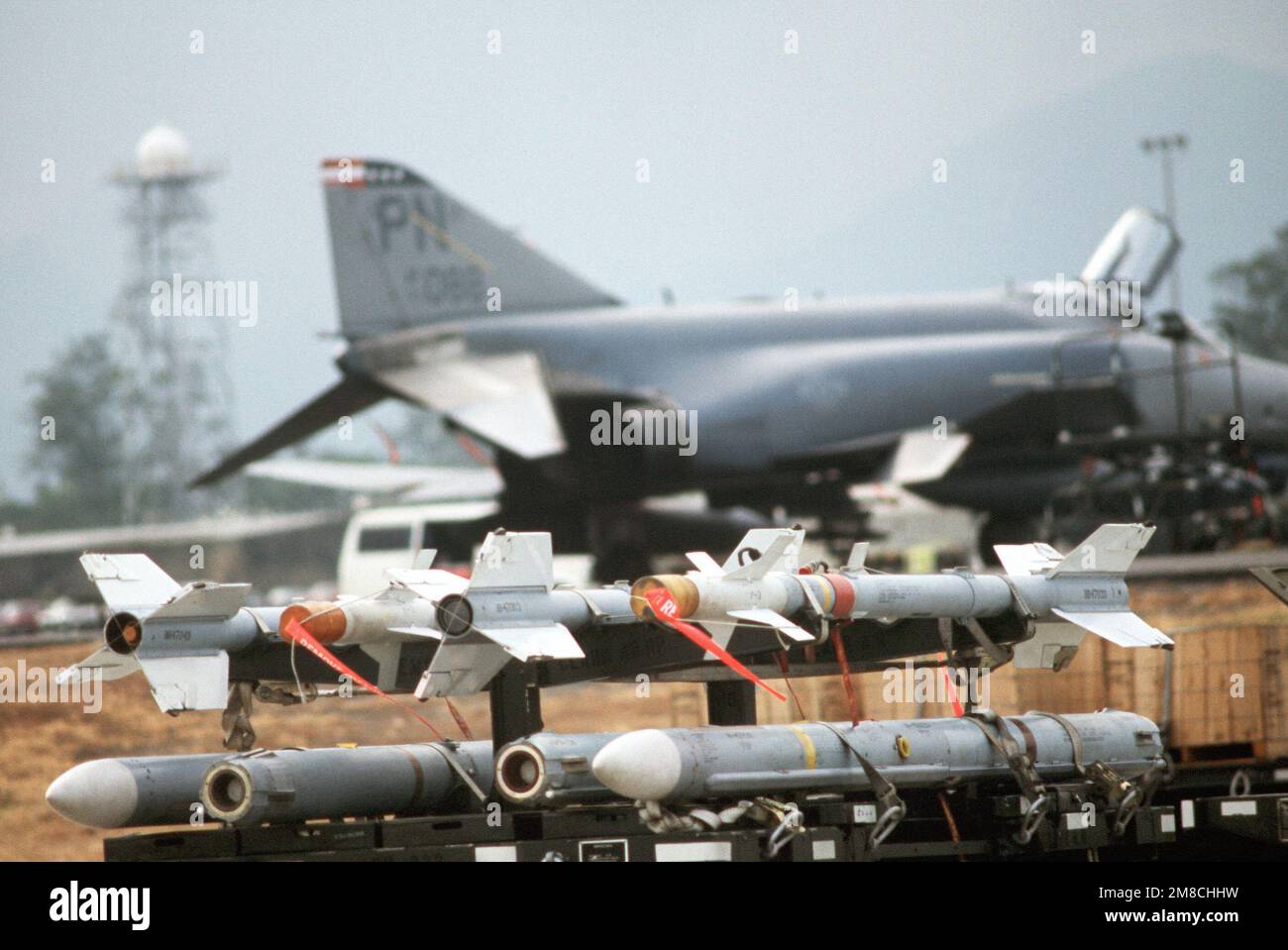 AIM-9 Sidewinder missiles, top, and AIM-7 Sparrow missiles sit on a ...