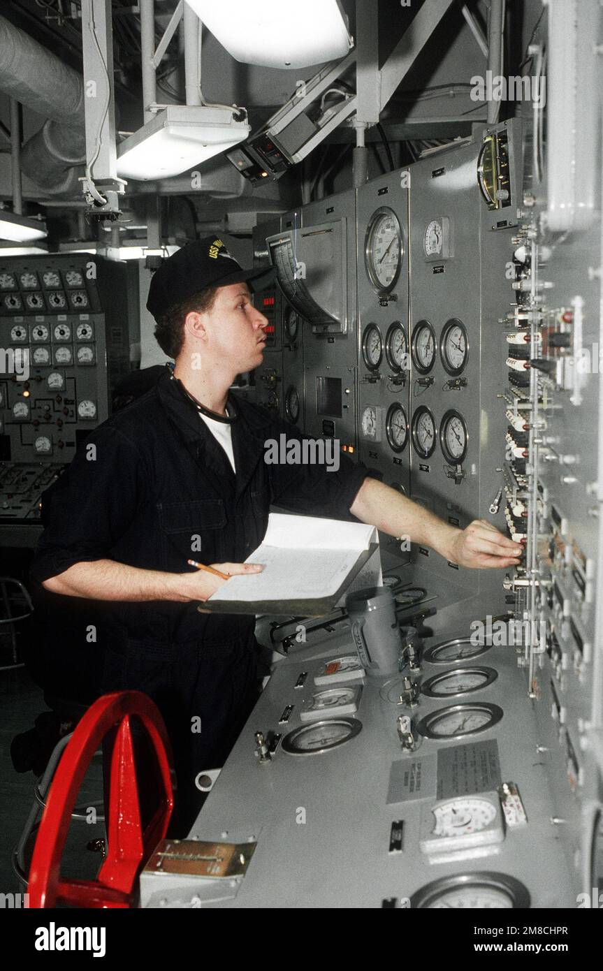 A technician monitors equipment in the main control room aboard the ...