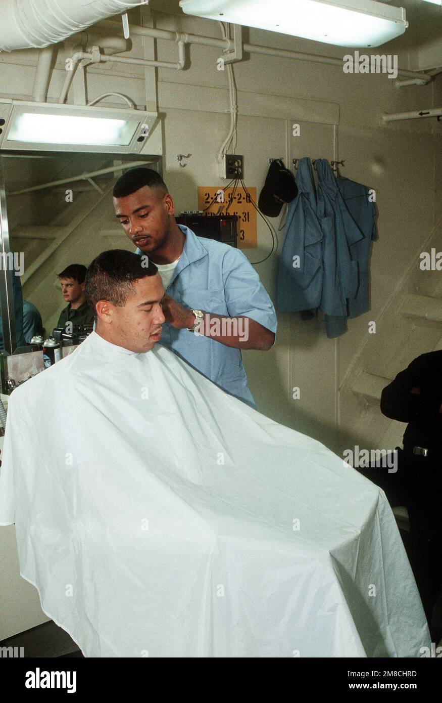 Ship's Serviceman SEAMAN Apprentice Jones gives a shipmate a haircut ...