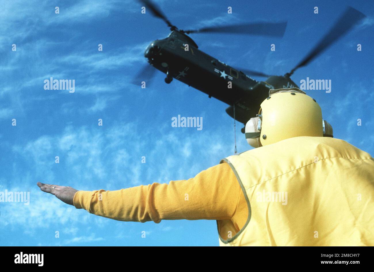 A plane director aboard the guided missile cruiser USS BELKNAP (CG 26 ...