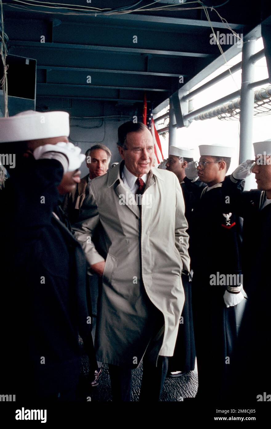 Sailors aboard the guided missile cruiser USS BELKNAP (CG 26) salute ...