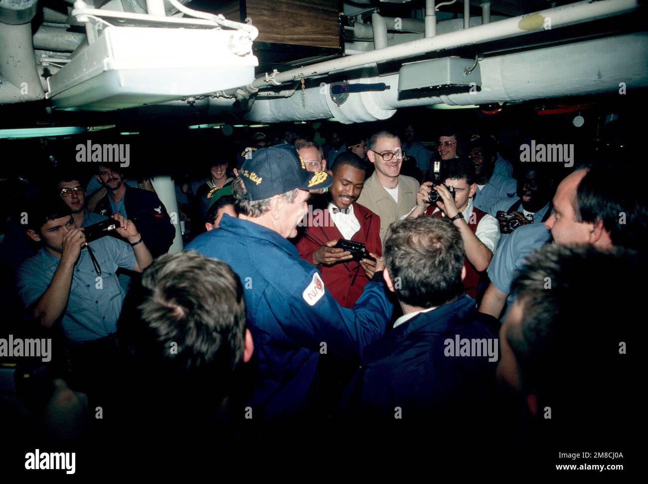 President George H.W. Bush is surrounded by well-wishers aboard the ...