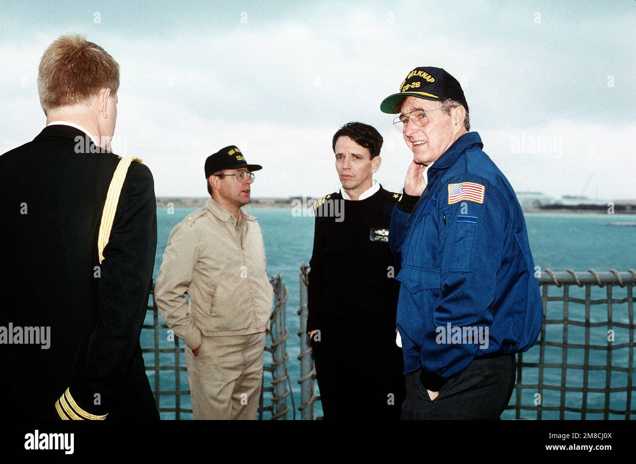 President George H. W. Bush visits with Navy personnel on the deck of ...
