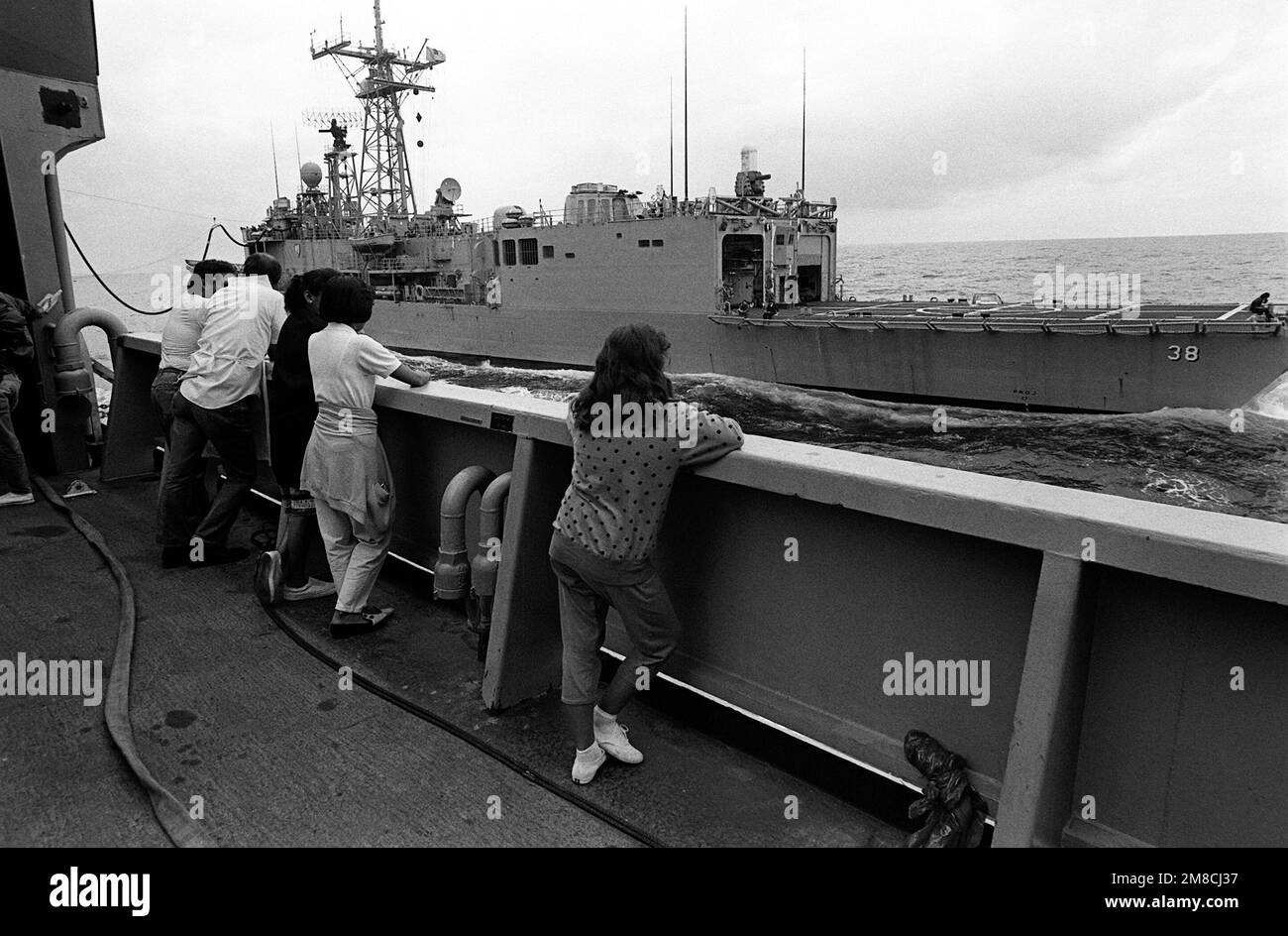Standing along the starboard side of the combat stores ship USNS SPICA ...