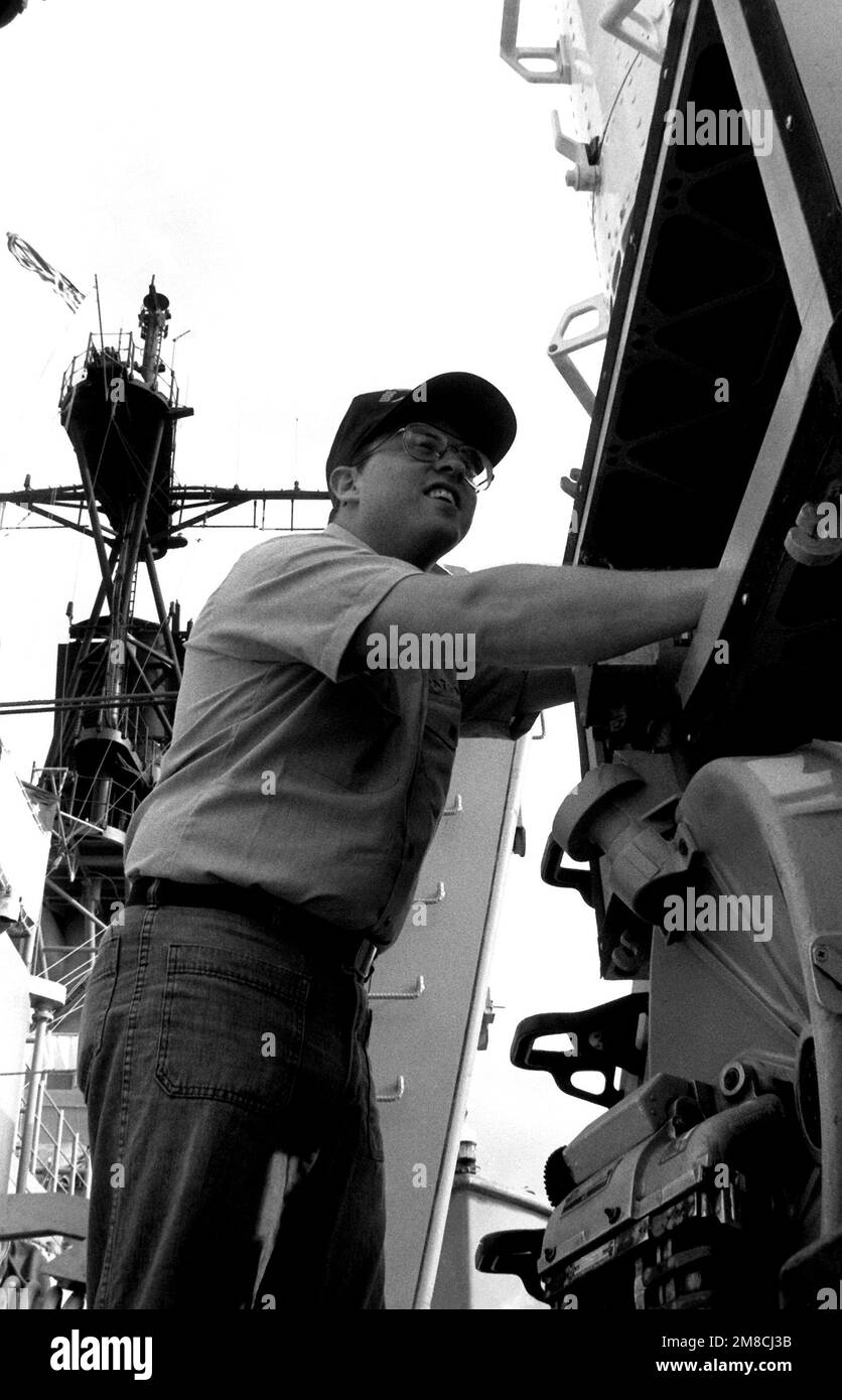 Fire Control Technician 3rd Class Richard Watson performs maintenance ...