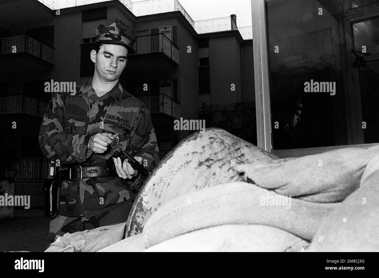 Electronics Technician 3rd Class Robert Overturf loads his .38-caliber ...