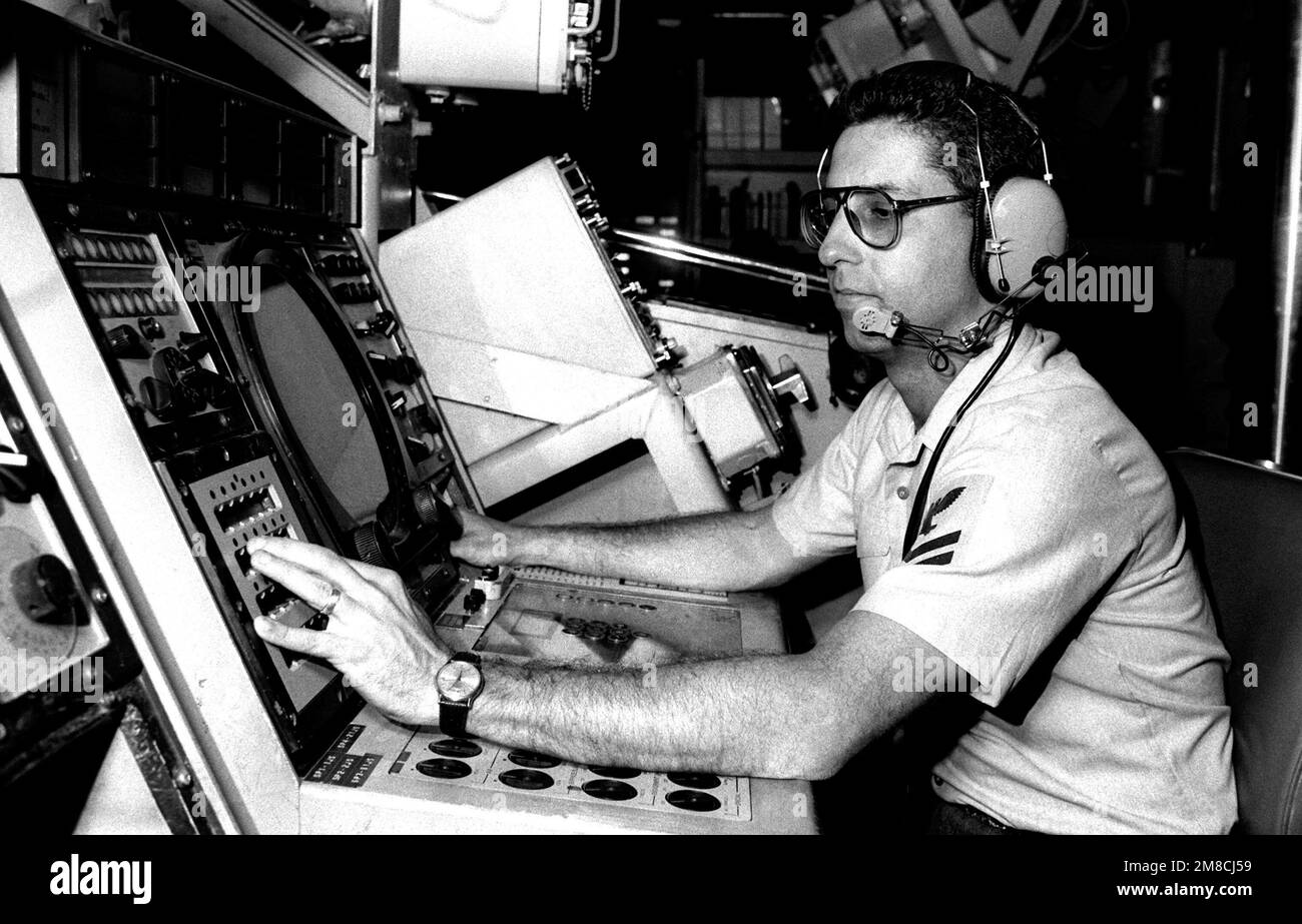 Operations SPECIALIST 2nd Class John Fatheree monitors a radar screen ...