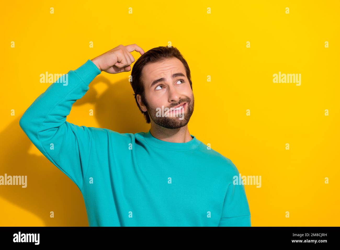 Photo of funny guy scratch finger head look empty space choose best ...