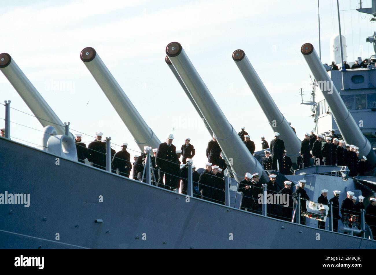 Crew members surround the Mark 7 16-inch/50 caliber guns from the No. 1 ...