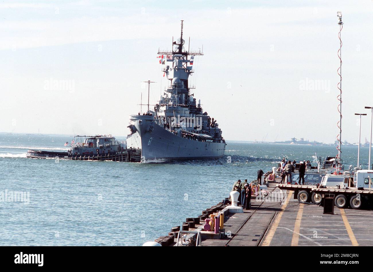 The large harbor tug WATHENA (YTB 825) maneuvers the battleship USS ...