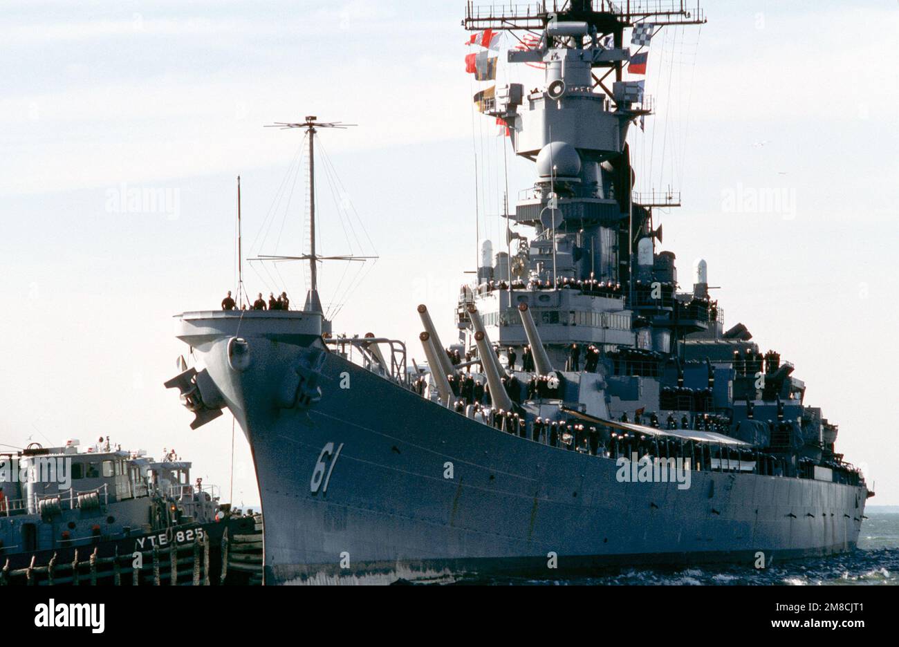 A port bow view of the battleship USS IOWA (BB 61) with crew members ...