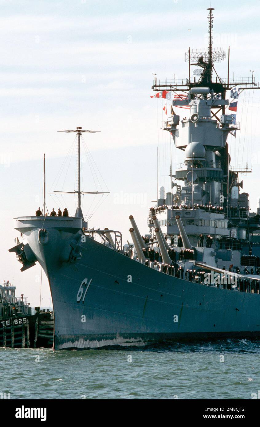 A port bow view of the battleship USS IOWA (BB 61) with crew members gathered at the rails as ...