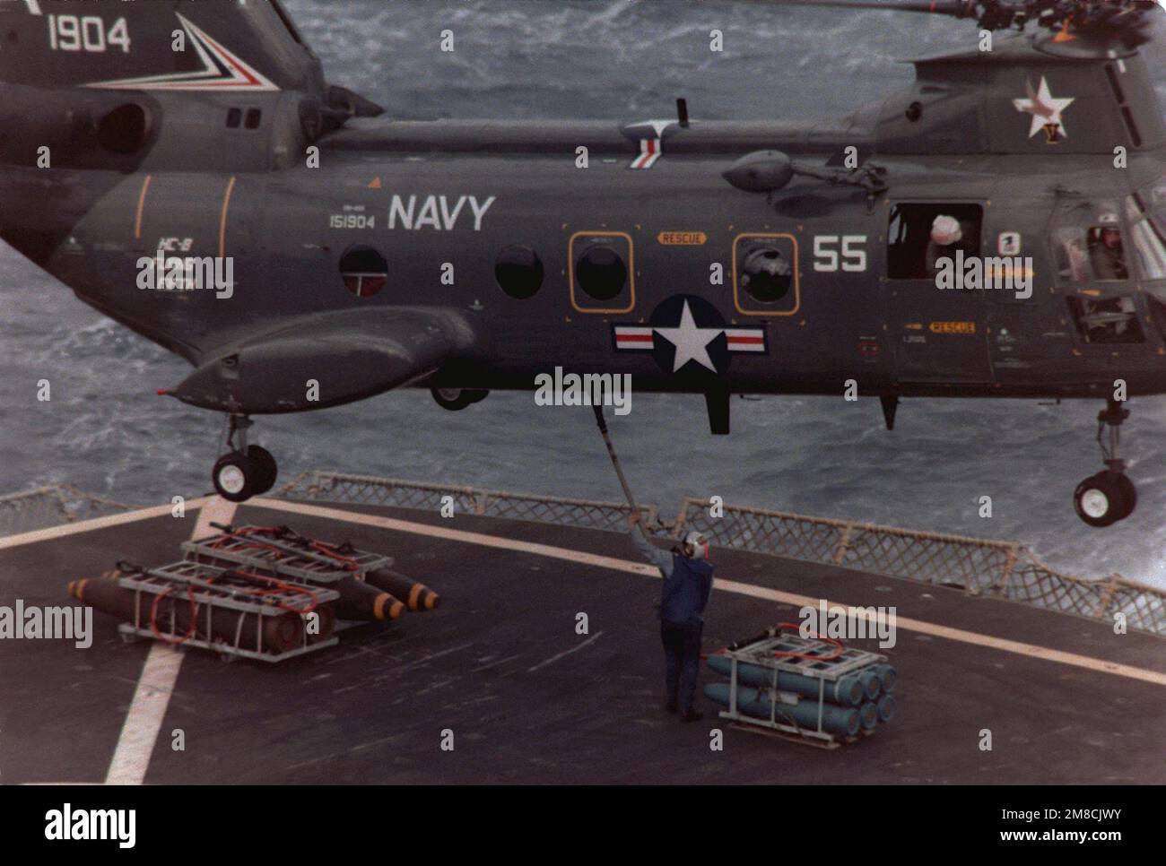 A crew member aboard the ammunition ship USS SANTA BARBARA (AE-28 ...