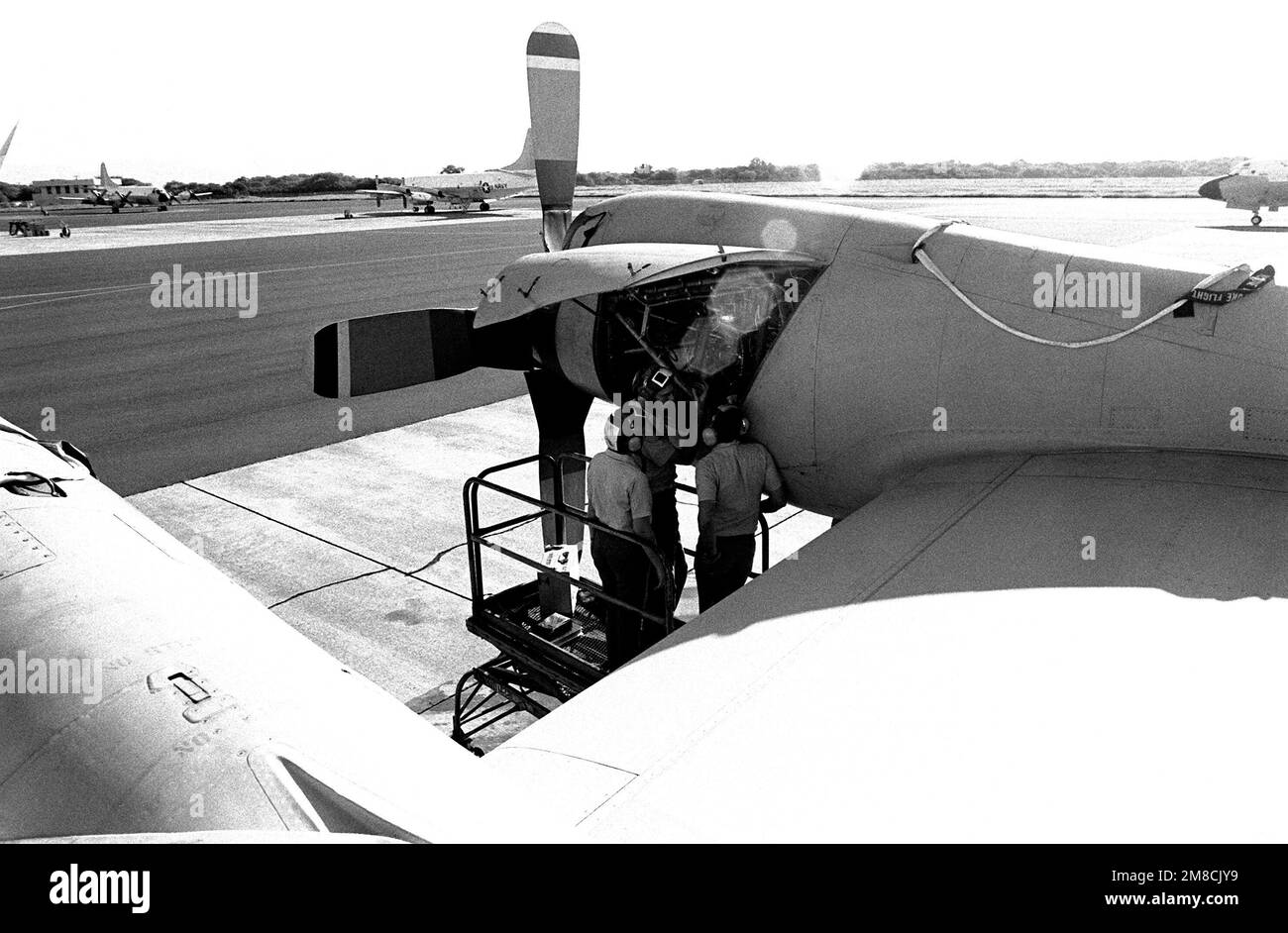 Ground crew members service an engine of a Naval Air Reserve Patrol ...