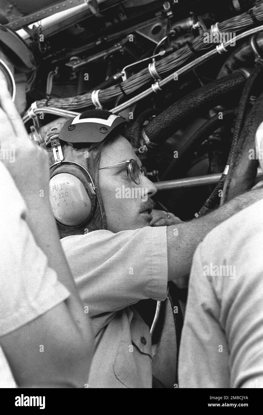 A mechanic works on an engine of a Naval Air Reserve Patrol Squadron 64 ...