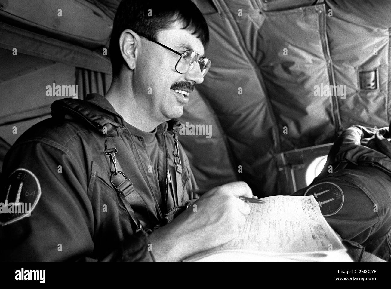 A crew member of a Naval Air Reserve Patrol Squadron 64 (VP-64) P-3 ...