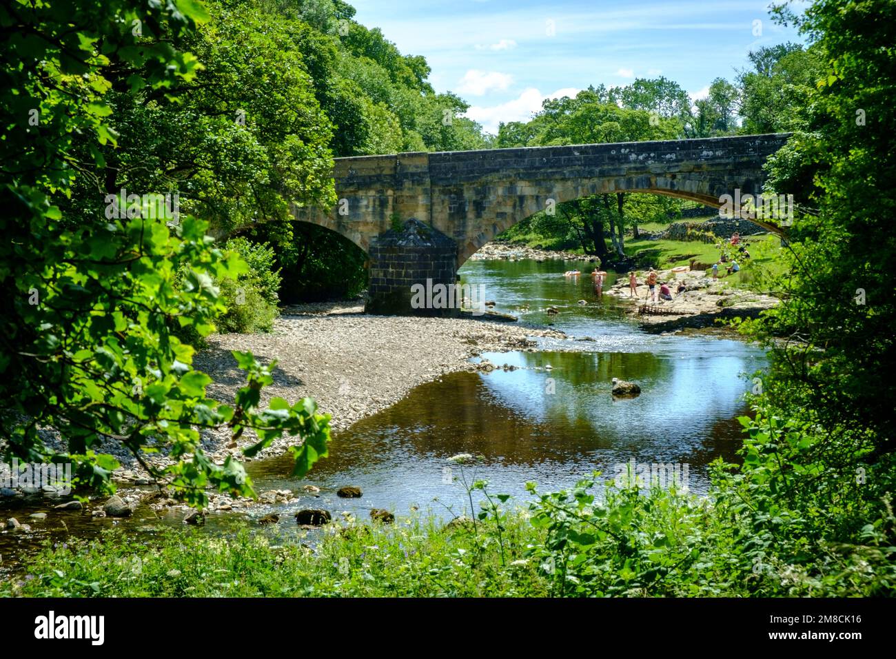 9th July 2022 - Kettlewell, UK: People in the River Wharfe during the ...