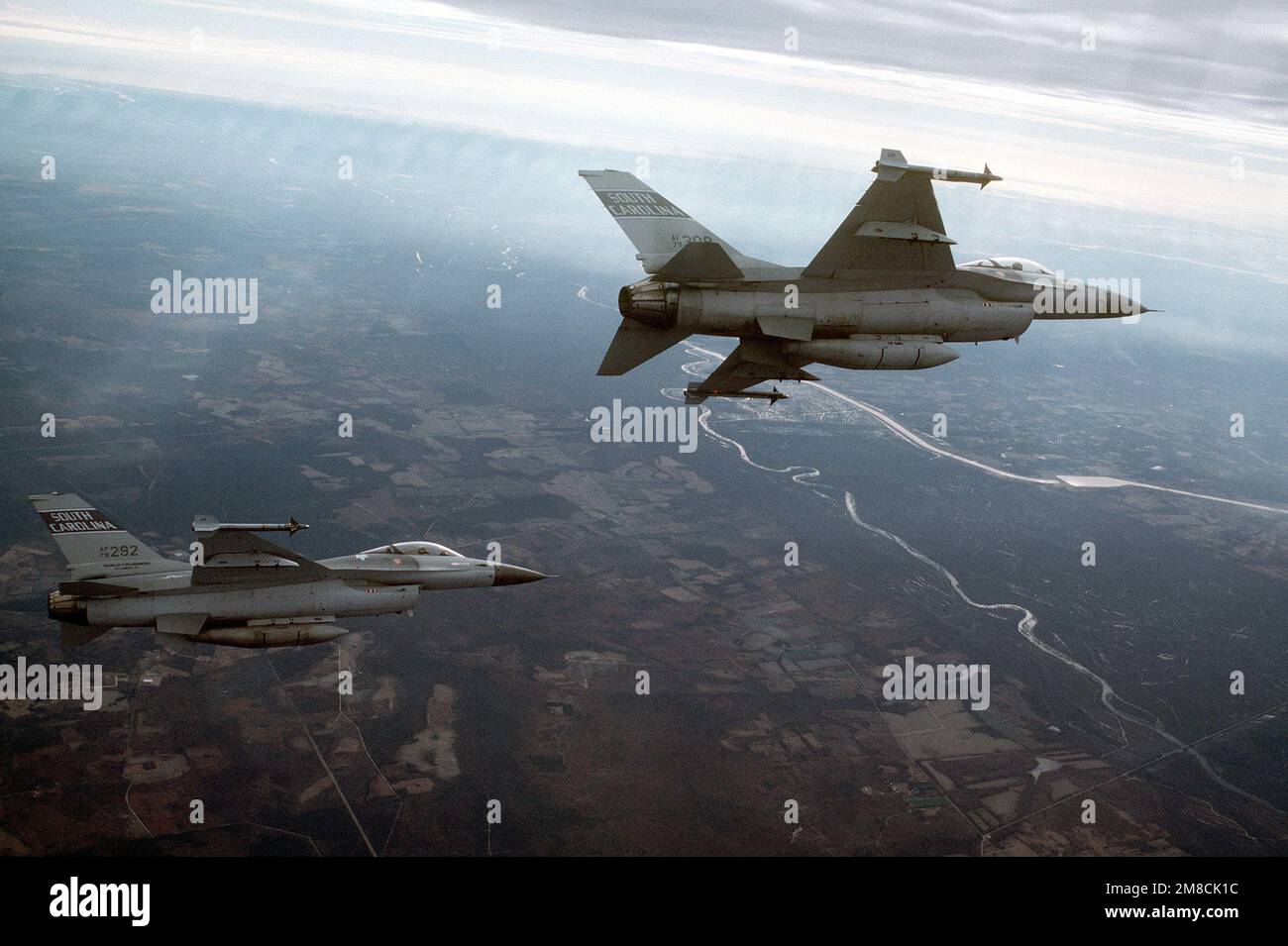 An air-to-air right side view of two 169th Tactical Fighter Group F-16 ...