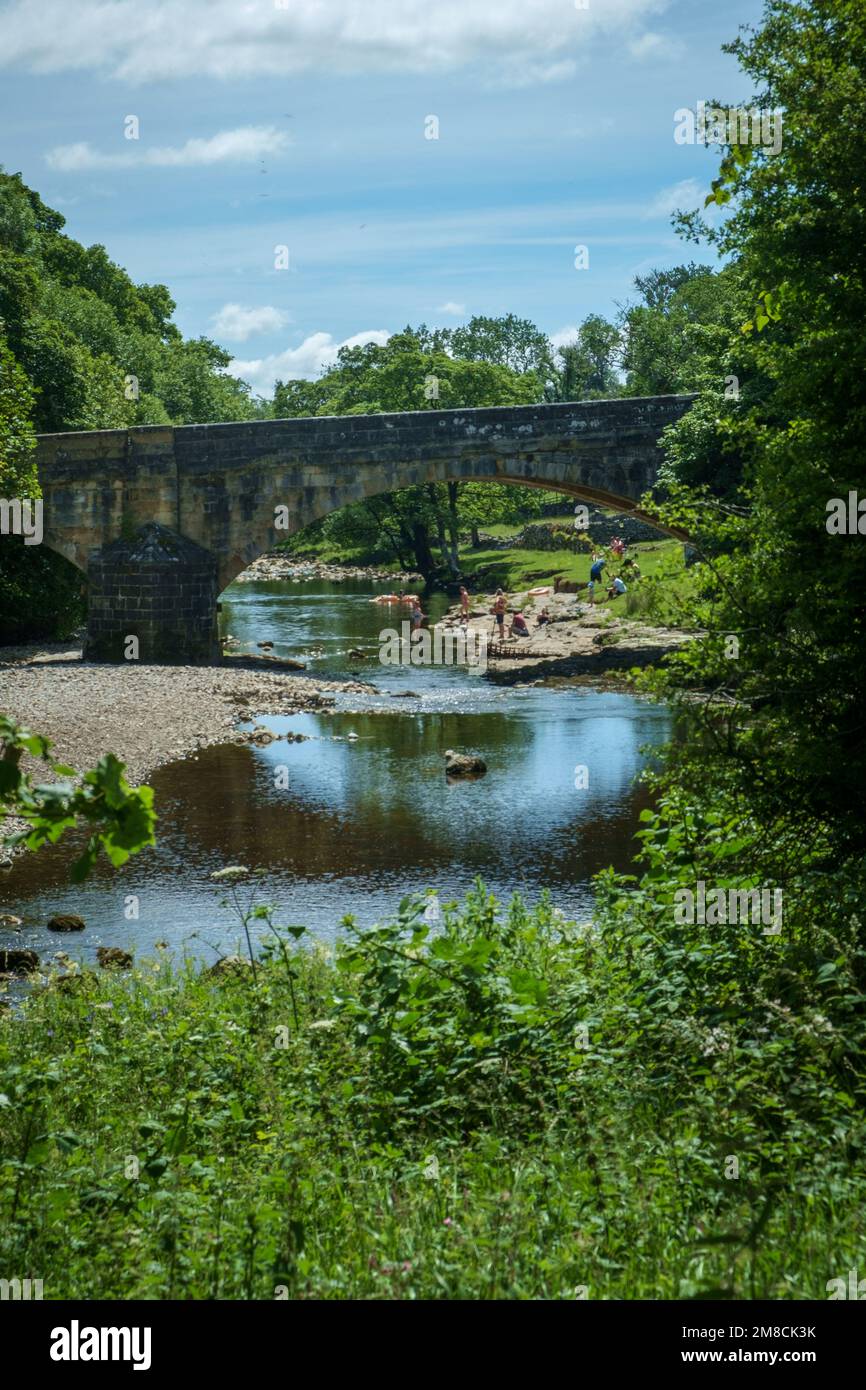9th July 2022 - Kettlewell, UK: People in the River Wharfe during the ...