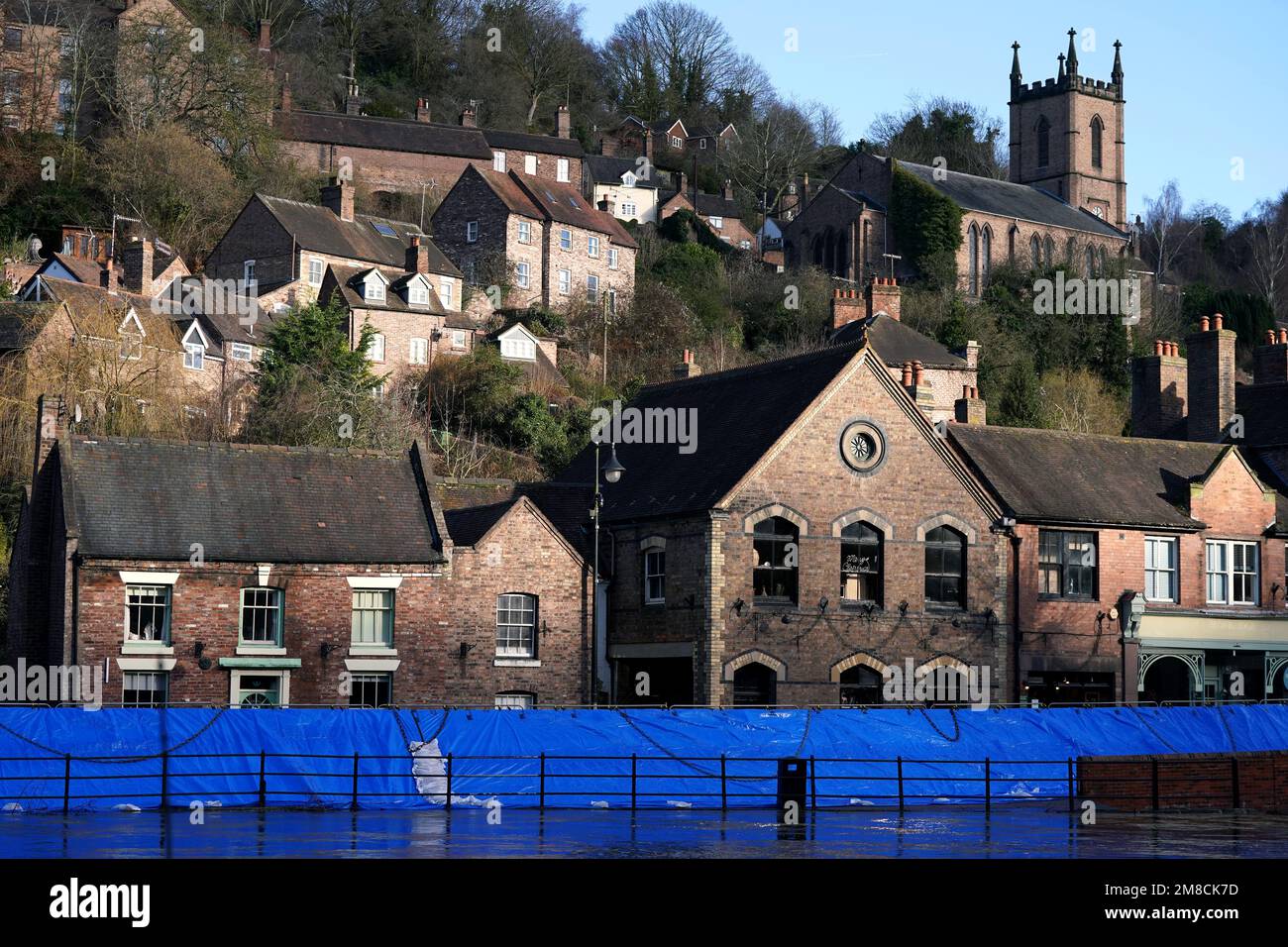 The swollen River Severn, as flood defences are in place along the ...