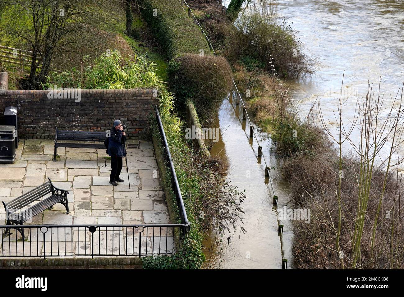 A photographer takes pictures of the swollen River Severn, as flood ...