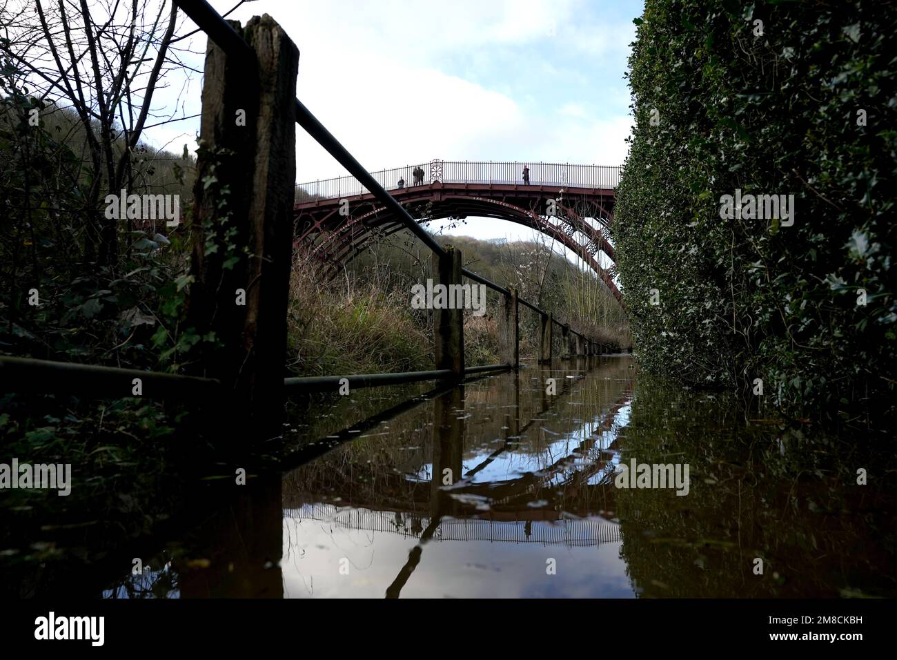 A flooded walkway along the swollen River Severn, as flood defences are ...