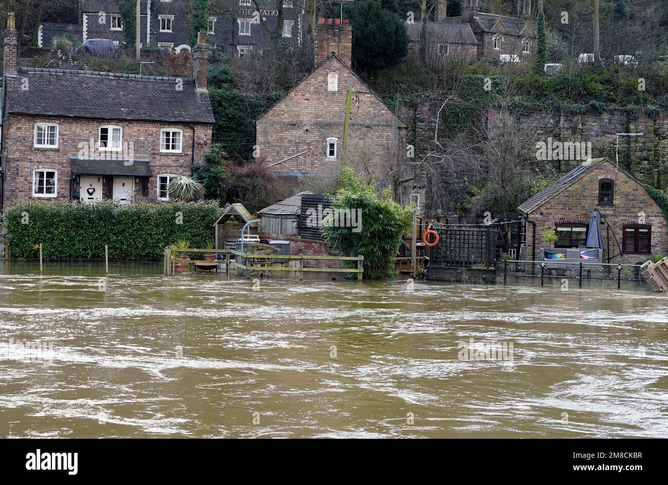 The Vic Haddock boat house (right) is flooded along the swollen River ...
