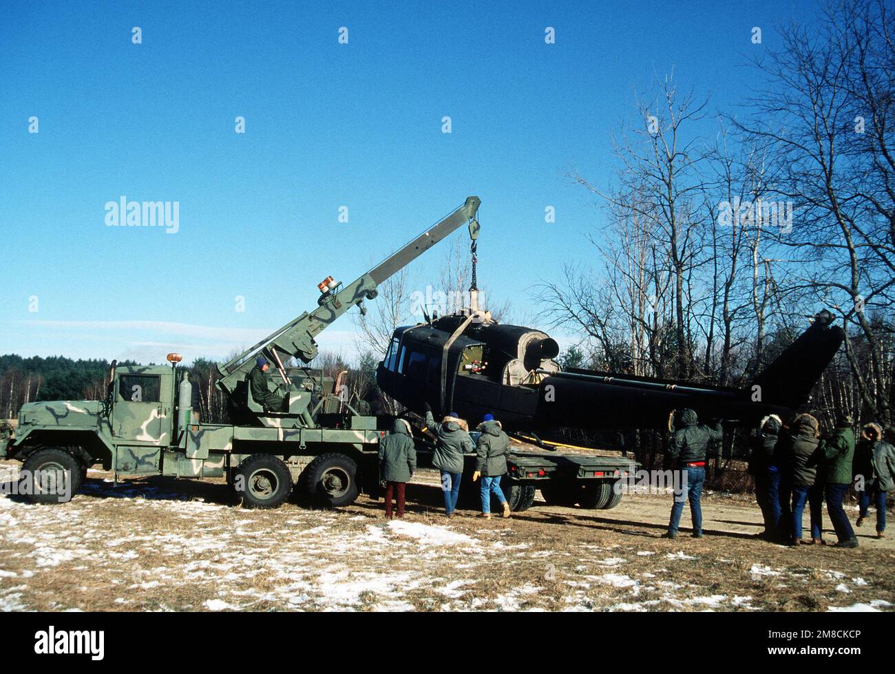 The crane on the back of an M-816 5-ton wrecker is used to lift a ...