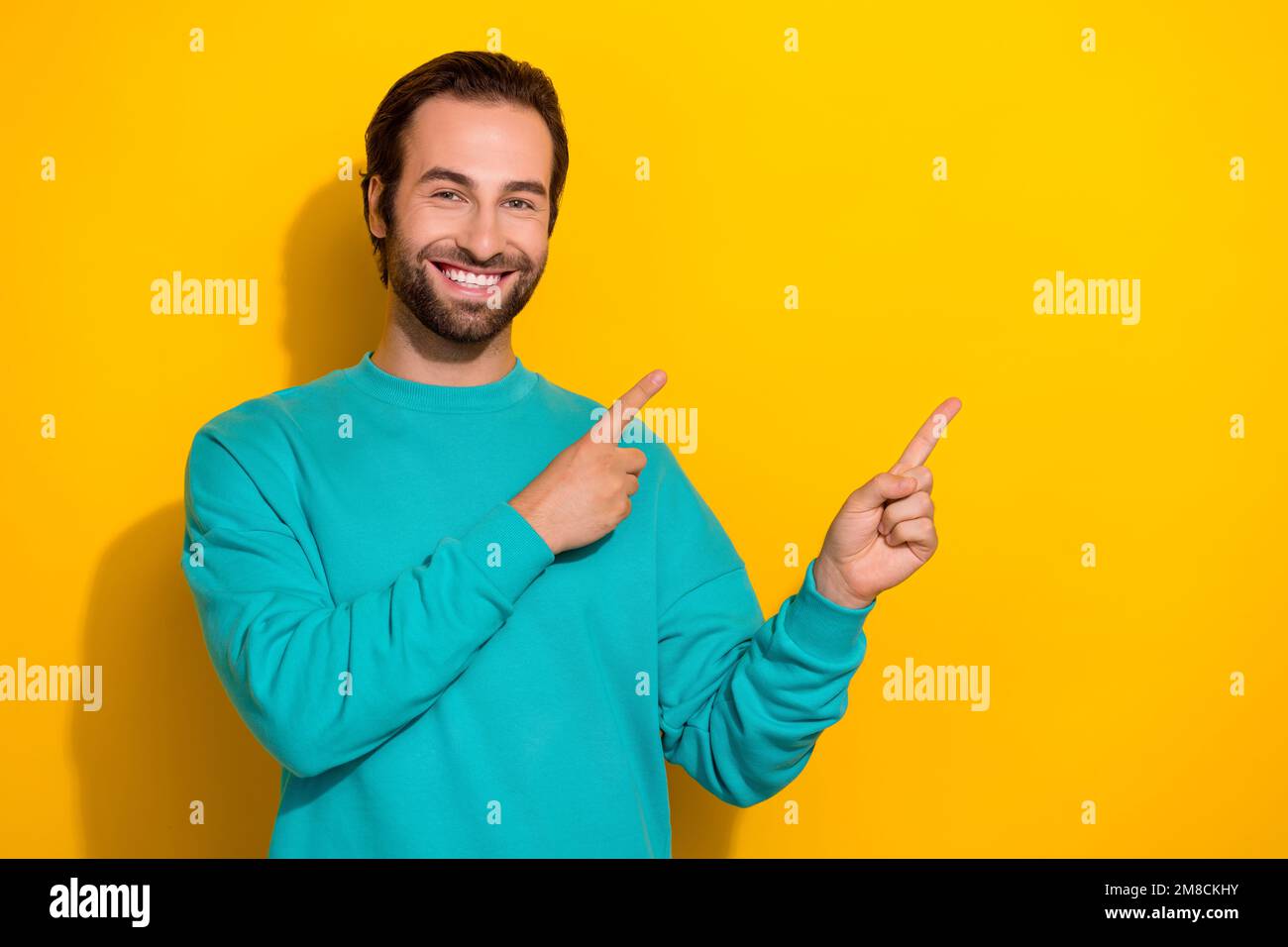 Photo of cheerful positive brunet hair man smiling fingers pointing ...