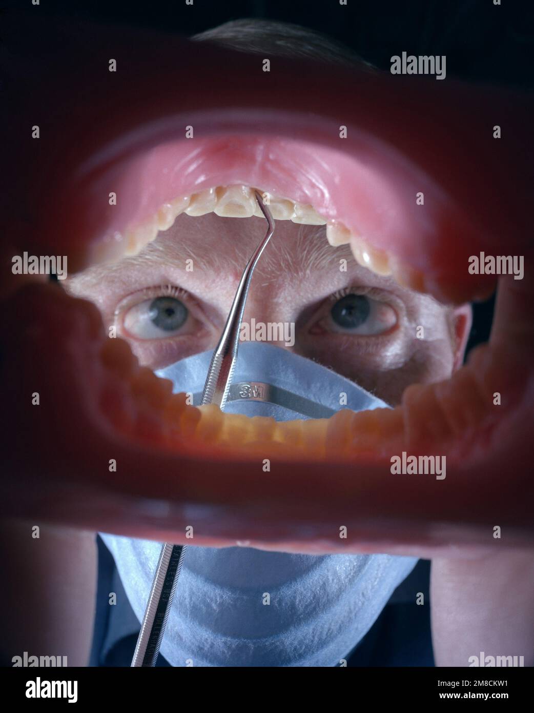 A dental officer aboard the nuclear-powered aircraft carrier USS ...