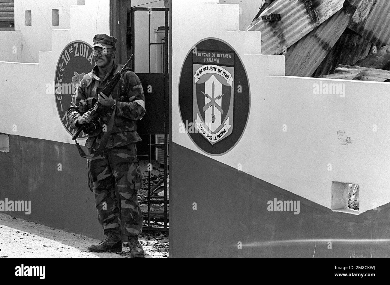 SGT. Chuck Jenks, a Marine photojournalist, pauses in the doorway of a ...