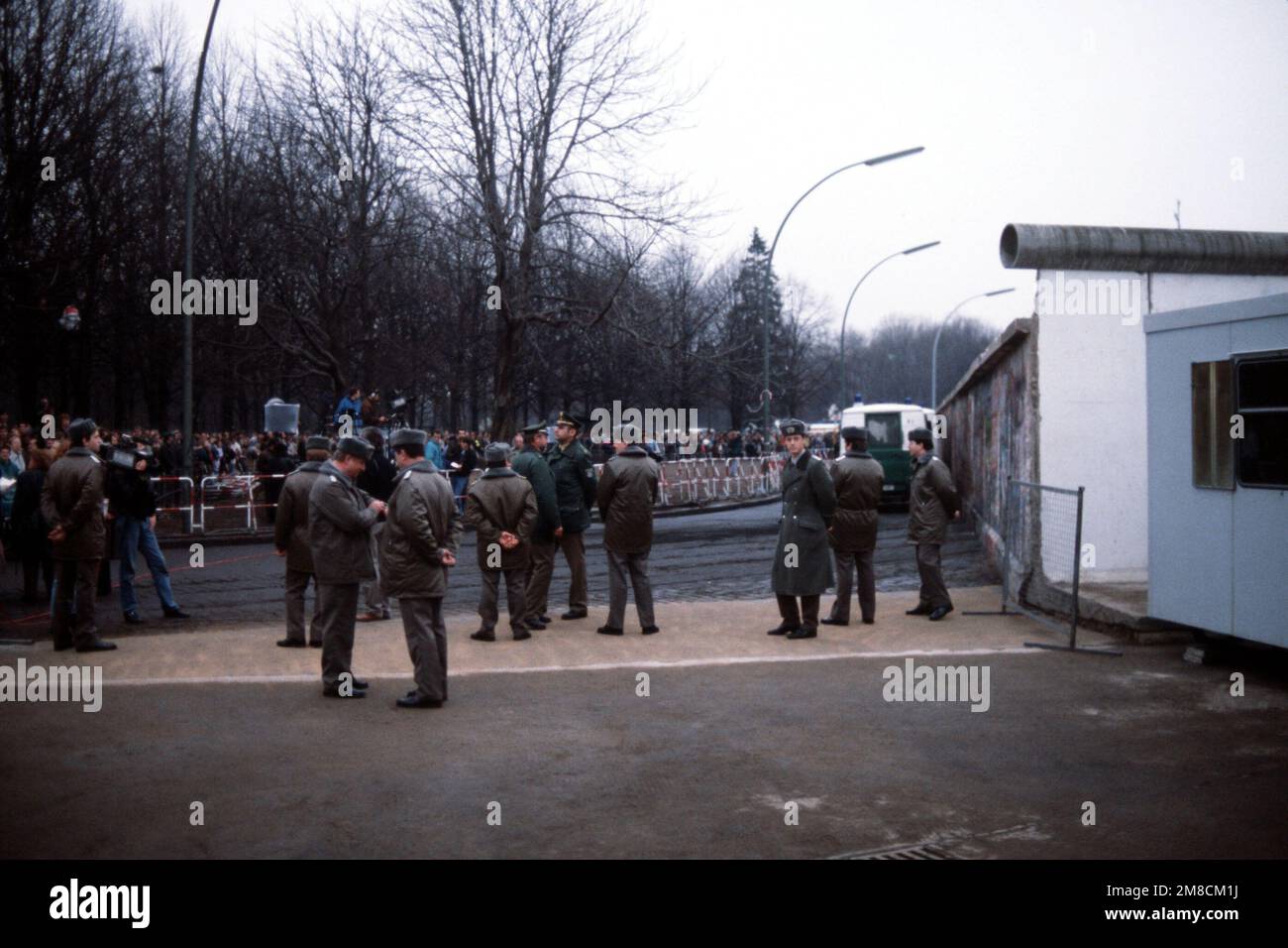 East German guards stand by the newly created opening in the Berlin ...