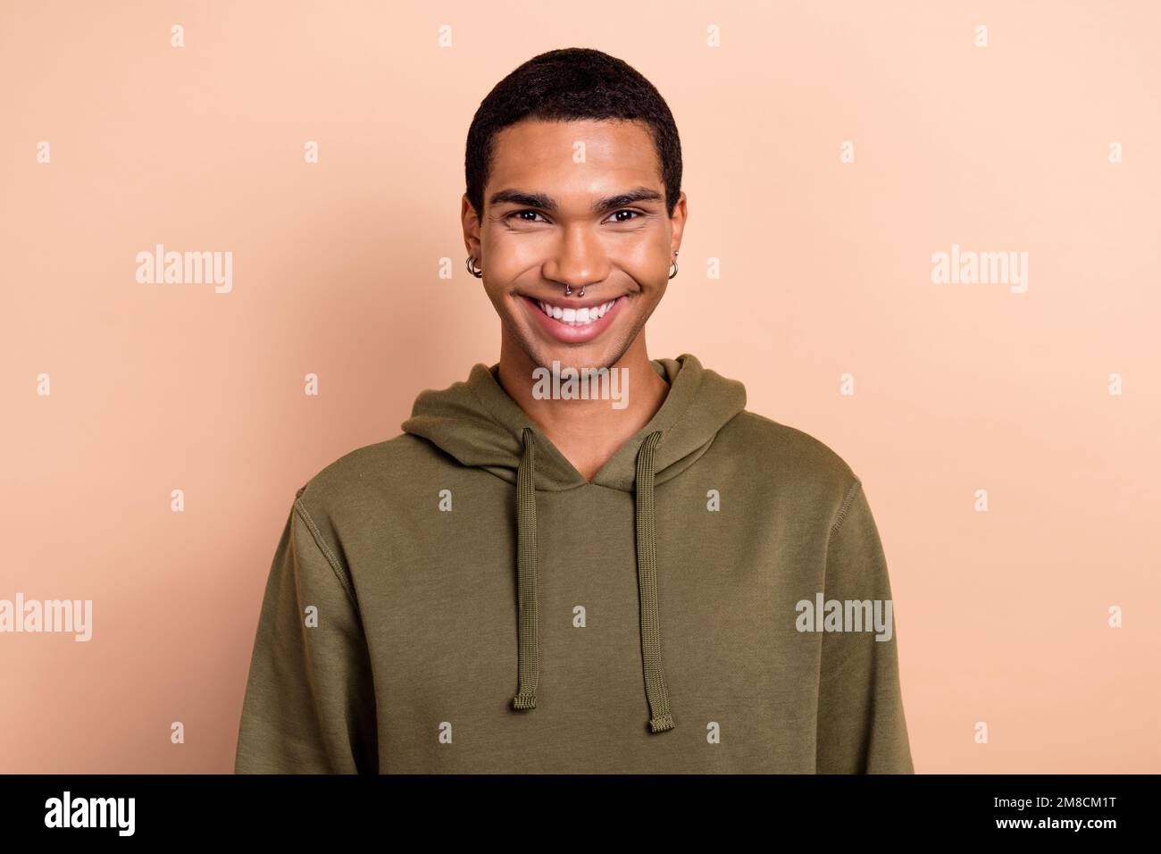 Photo of cheerful positive guy dressed green khaki hoodie smiling ...