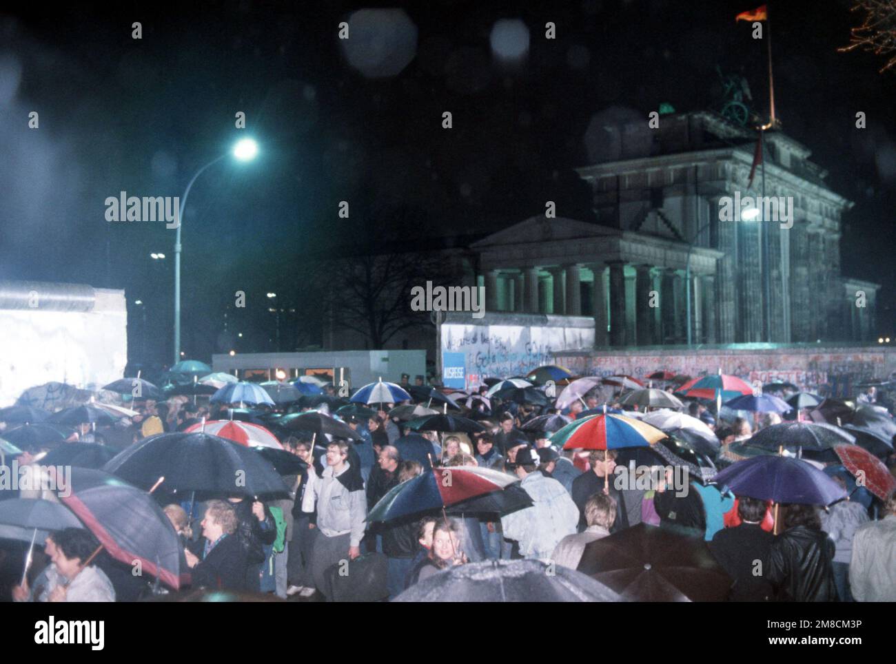 Crowds brave the weather to gather at the newly opened Brandenburg Gate ...