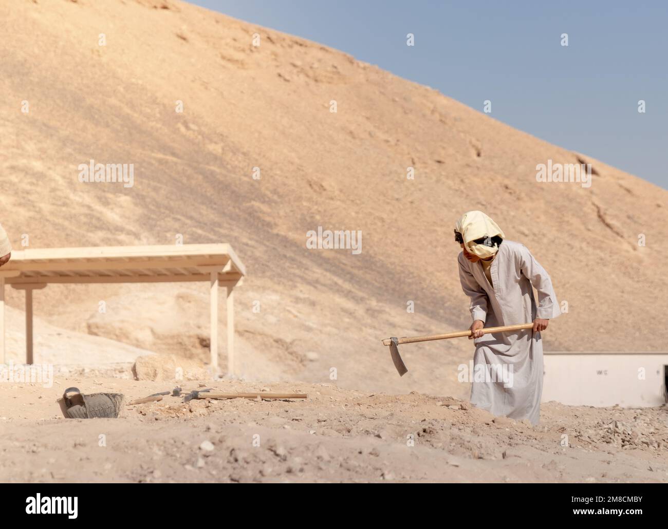 LUXOR, EGYPT - 27 Dec 2022. Hard working arab man with turban using ...