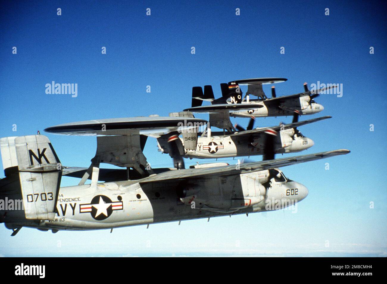 An air-to-air right side view of three E-2C Hawkeye aircraft of ...