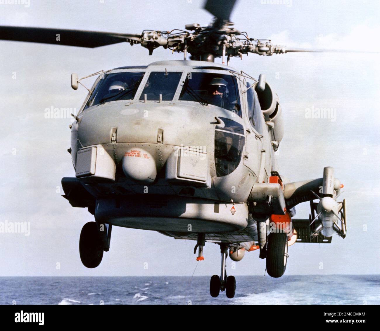 An SH-60B Sea Hawk helicopter carrying an AGM-119B (Mark 2 Mod 7 ...