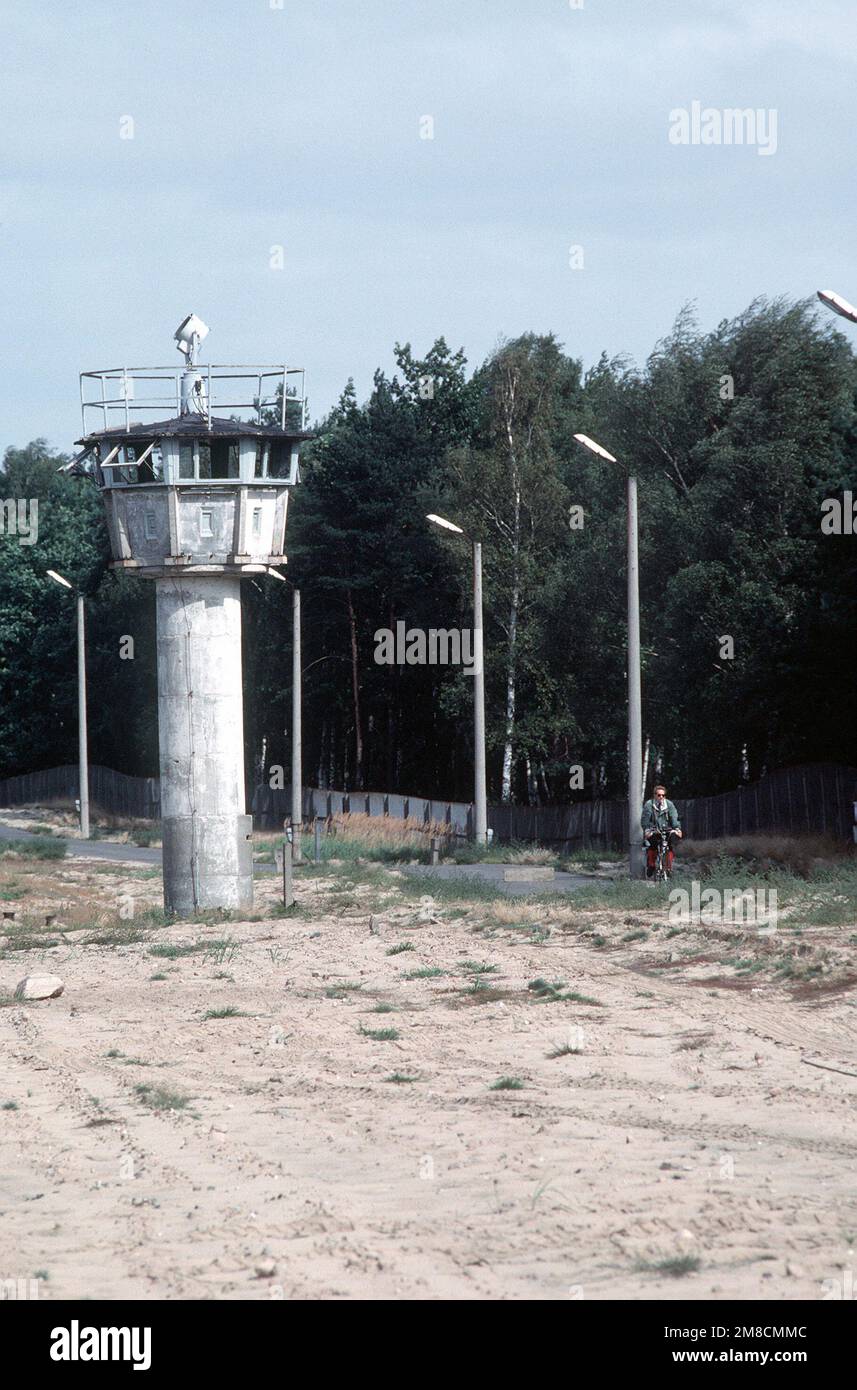 A cyclist passes an abandoned watchtower at the former Checkpoint Bravo ...