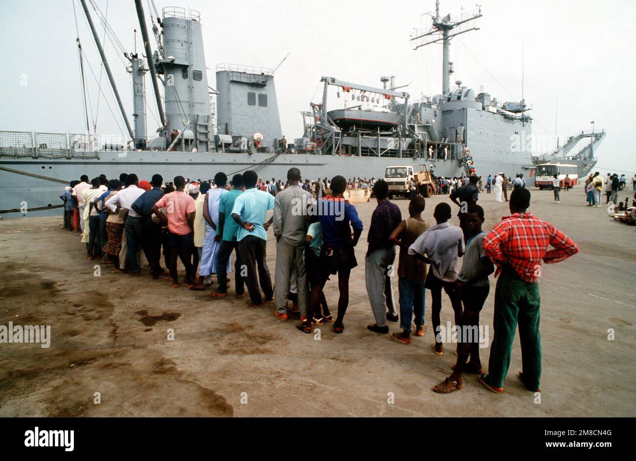 Local residents line up to see the tank landing ship USS BARNSTABLE ...