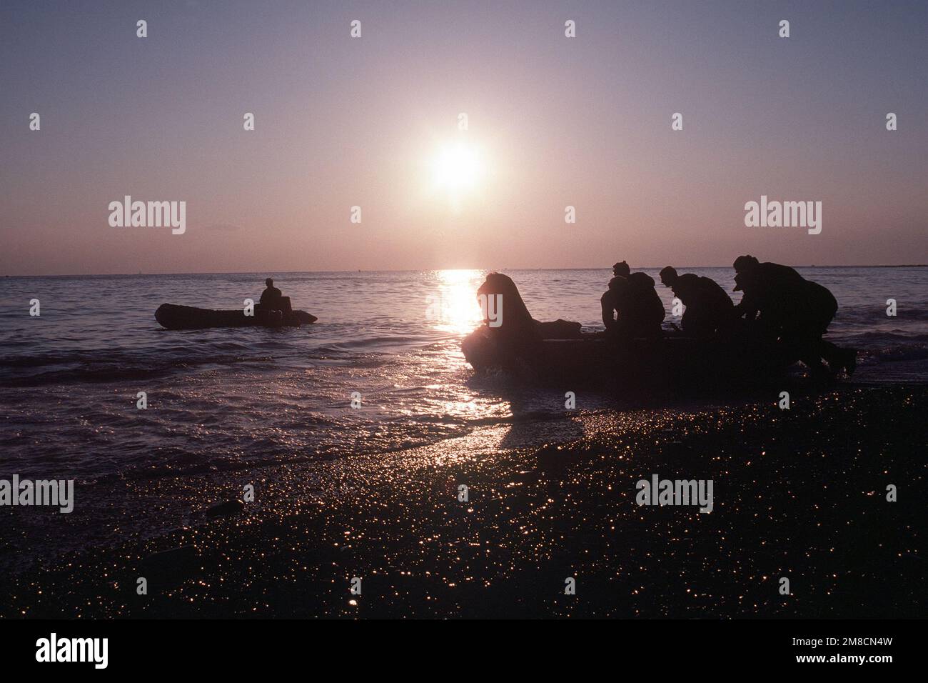 Members of a U.S. Navy sea-air-land (SEAL) team push their inflatable ...