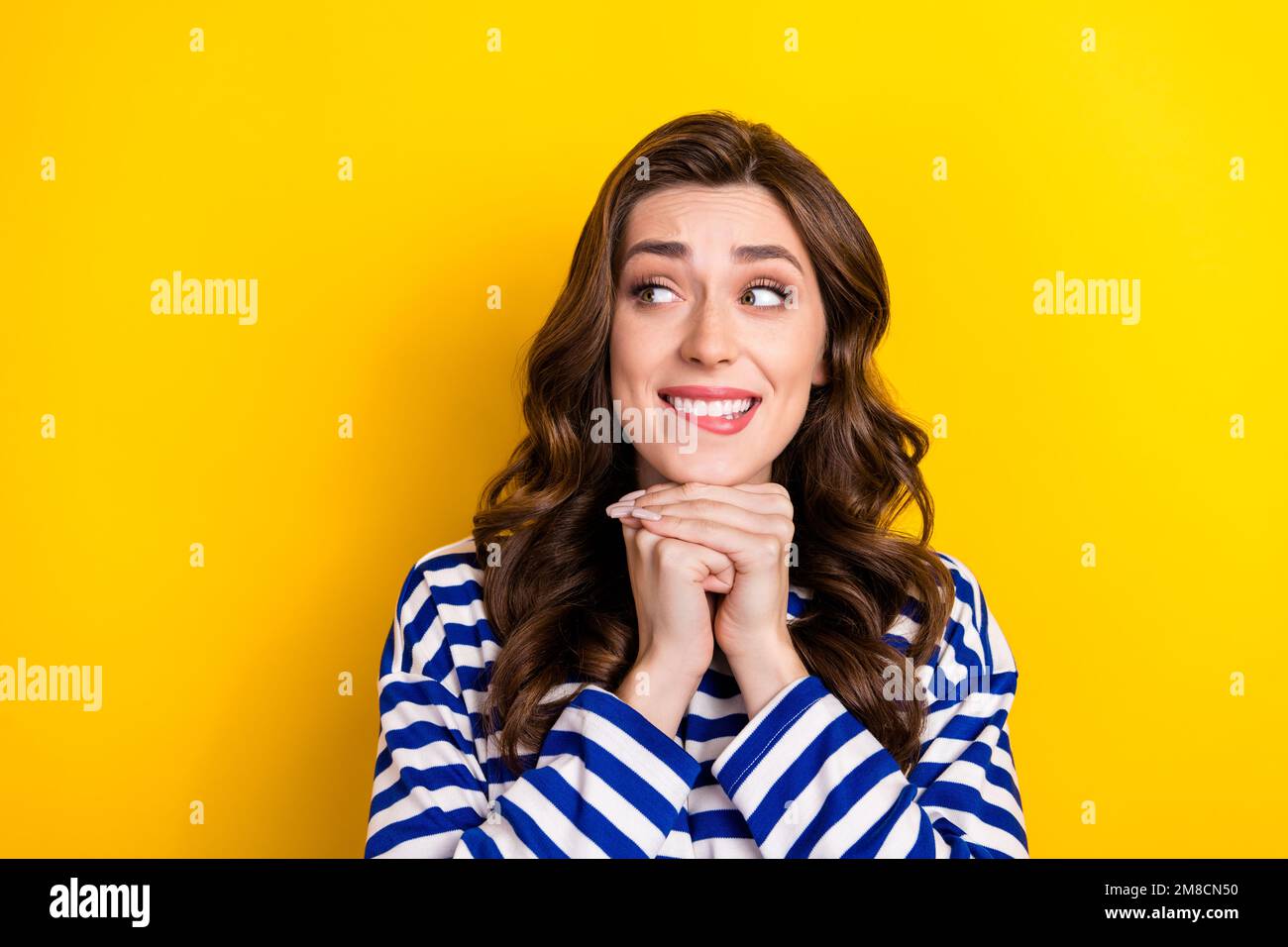 Photo of young nervous impressed woman brown wavy hair biting lips ...
