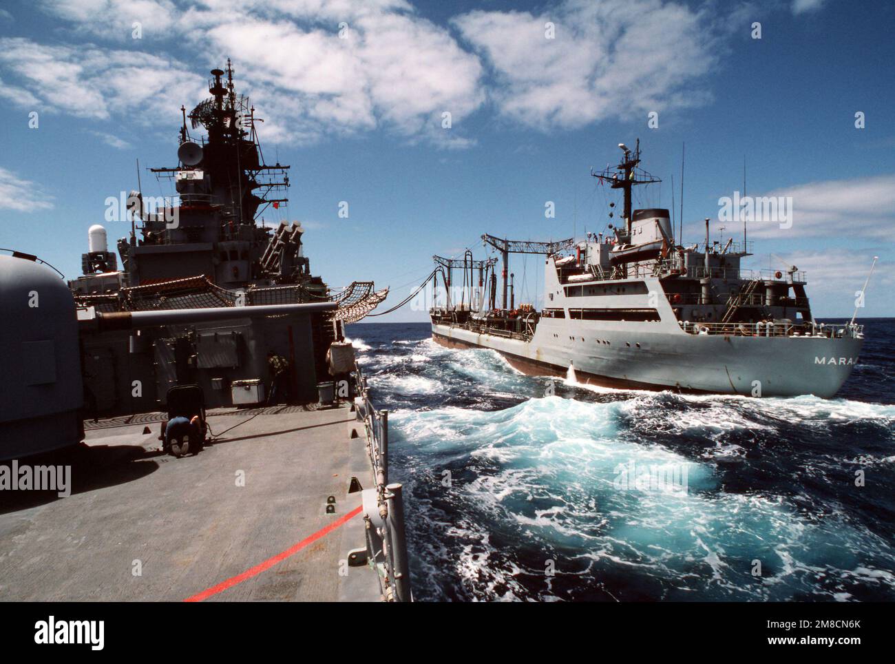 The guided missile cruiser USS JOSEPHUS DANIELS (CG 27) takes on fuel ...
