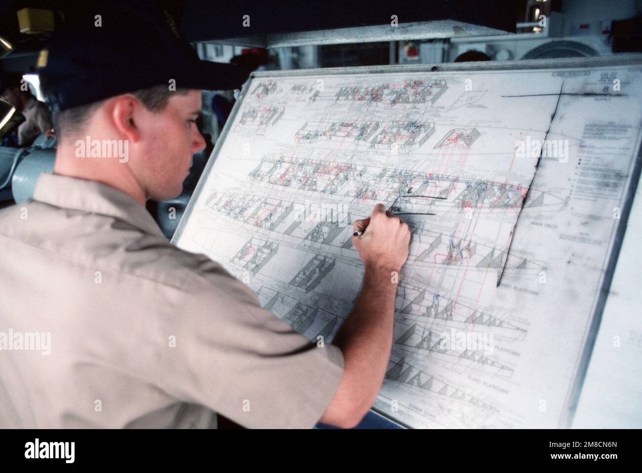 A bridge officer marks flood boundaries and damaged compartments on a ...
