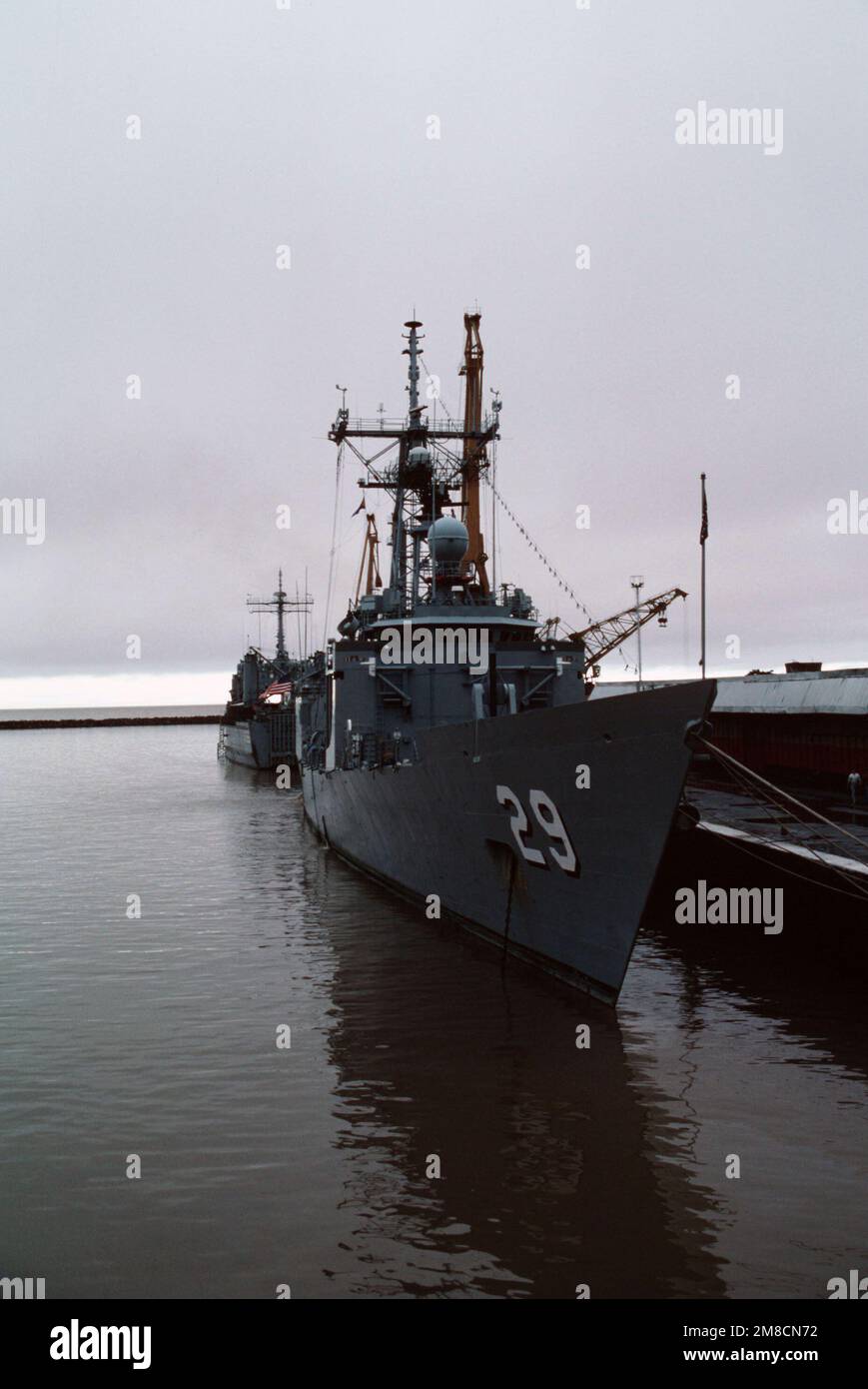The guided missile frigate USS STEPHEN W. GROVES (FFG 29) is moored to ...