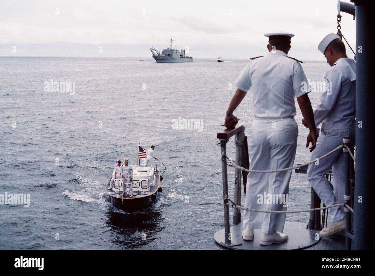 The captain's gig returns to the guided missile cruiser USS JOSEPHUS ...